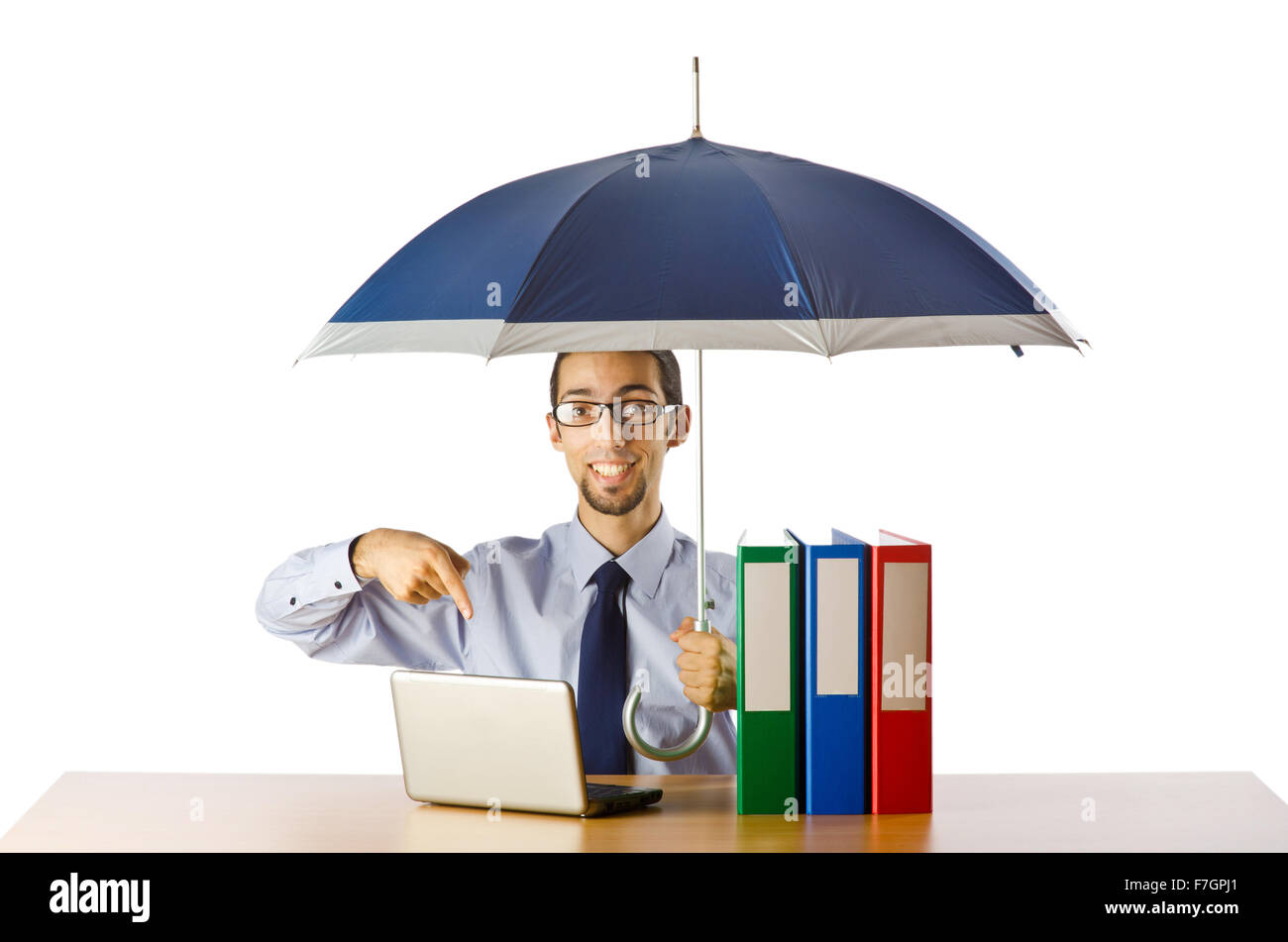 Businessman holding umbrella in the office Stock Photo - Alamy