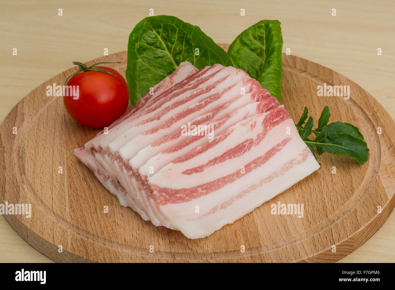 Sliced Bacon with herbs on the wooden bckground Stock Photo - Alamy