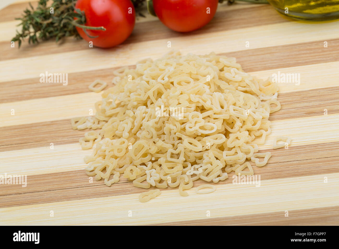 Raw ABC macaroni on the wood background Stock Photo - Alamy