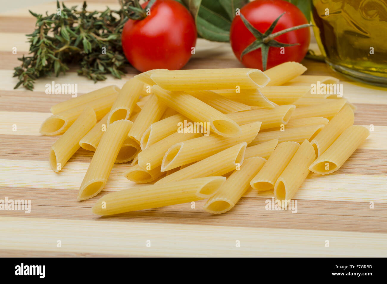 Raw penne pasta on the wood background Stock Photo - Alamy