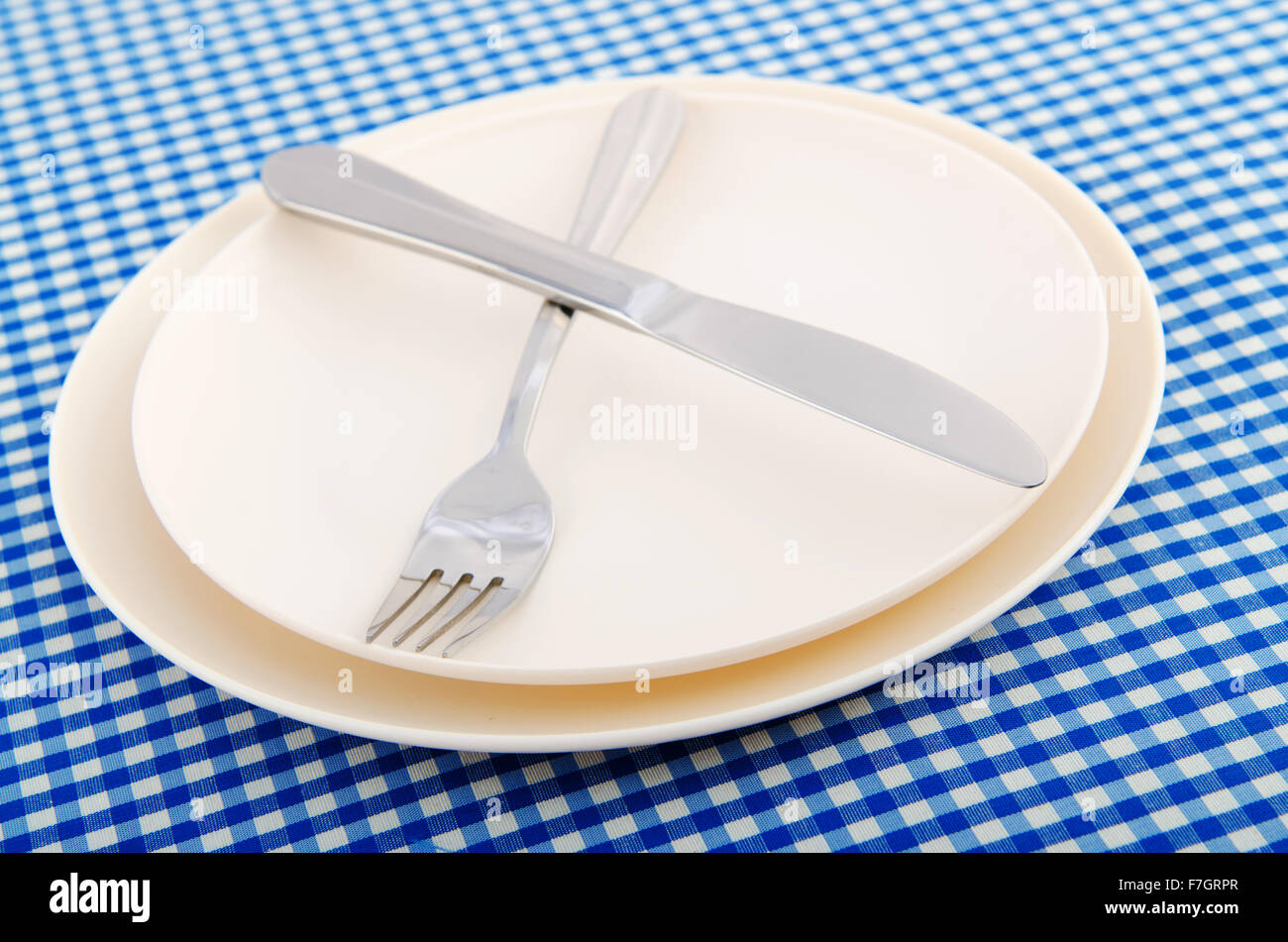 Empty plate with utensils Stock Photo - Alamy