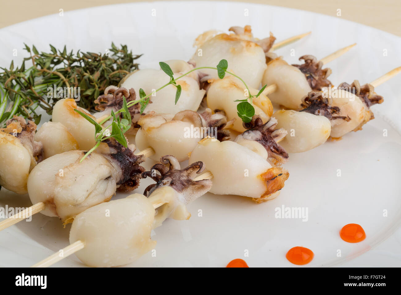 Grilled cuttlefish bbq with rosemary and pepper Stock Photo - Alamy