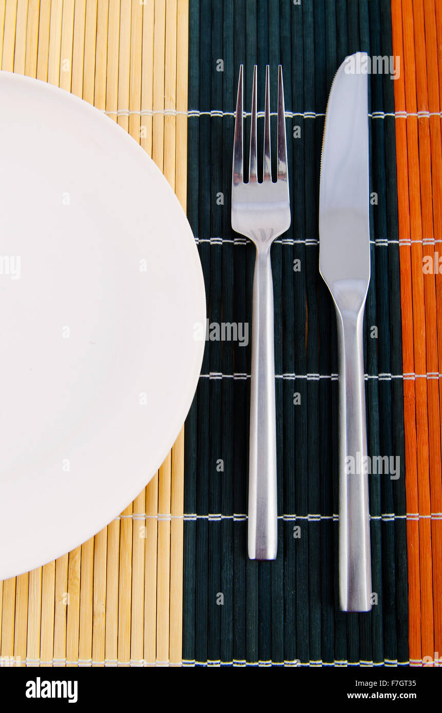 Empty plate with utensils Stock Photo - Alamy