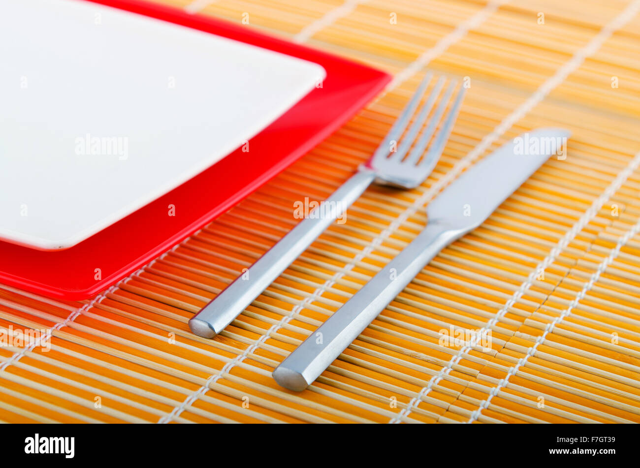 Empty plate with utensils Stock Photo - Alamy