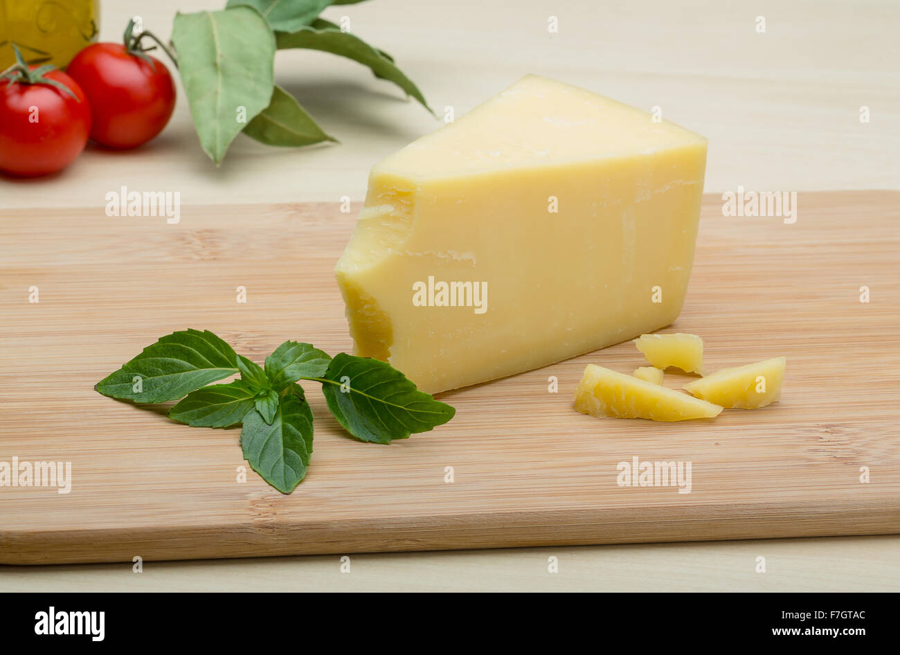 Parmesan cheese with basil leaves on the wood background Stock Photo ...