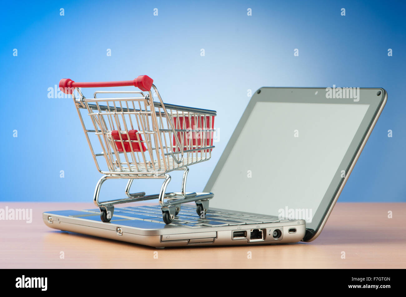 Internet online shopping concept with computer and cart Stock Photo - Alamy
