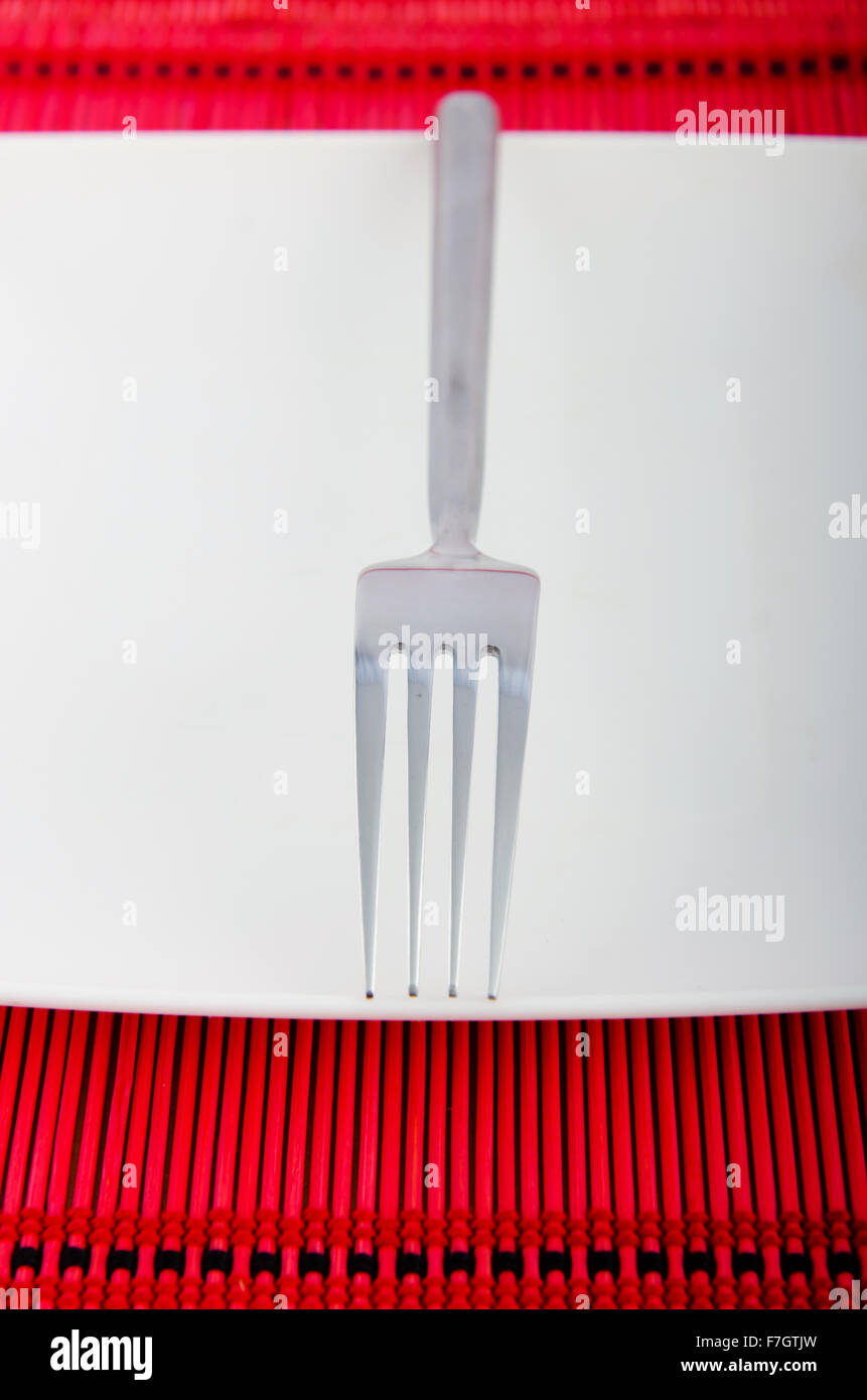 Empty plate with utensils Stock Photo - Alamy