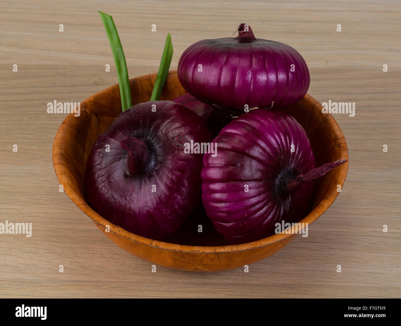 Violet onion in the basket with green Stock Photo - Alamy