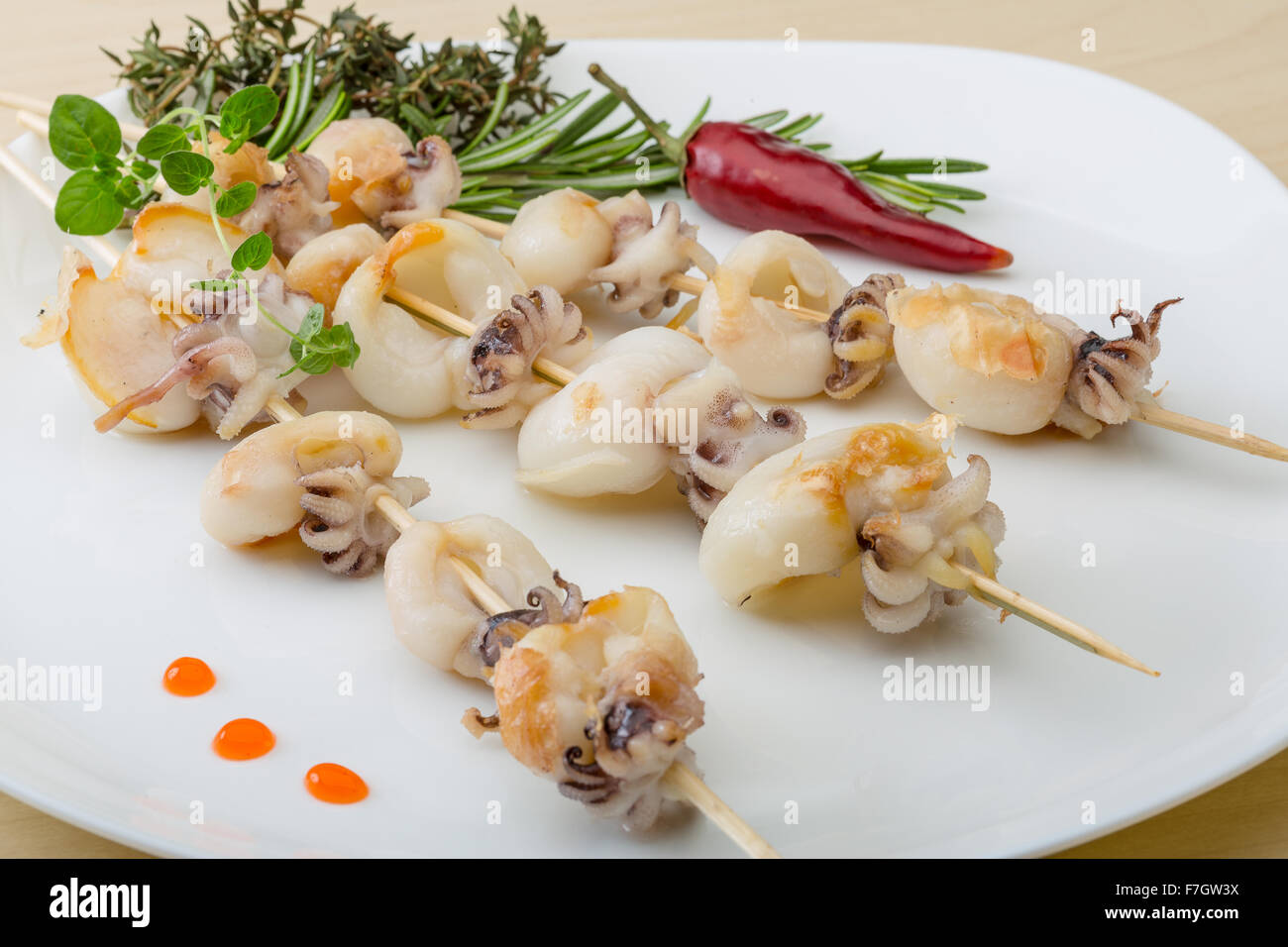 Grilled cuttlefish bbq with rosemary and pepper Stock Photo - Alamy