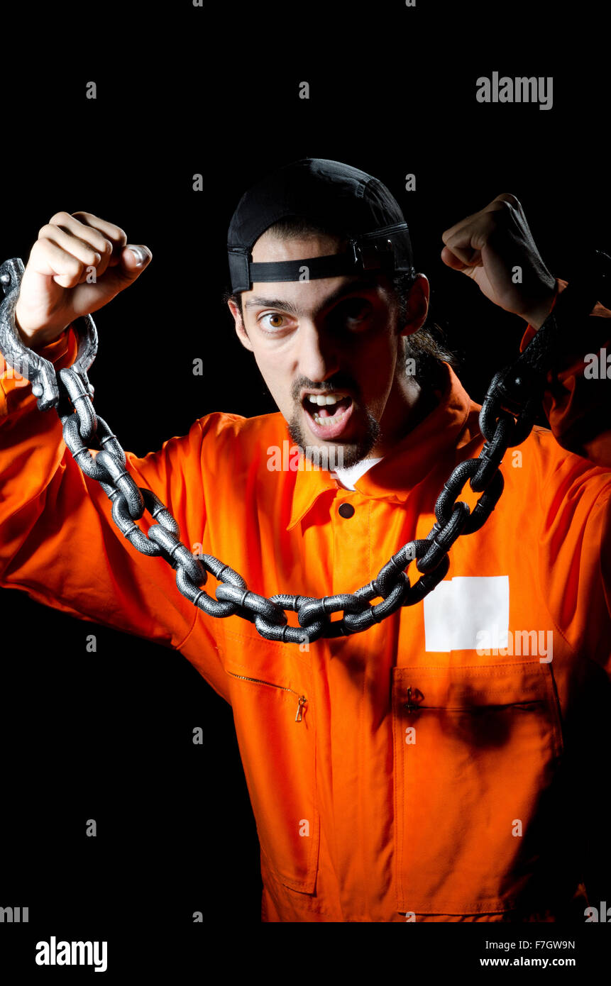 Inmate chained on black background Stock Photo - Alamy
