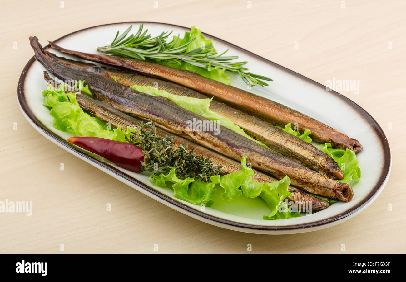 Smoked Lamprey - seafood delicacy with salad and herbs Stock Photo - Alamy