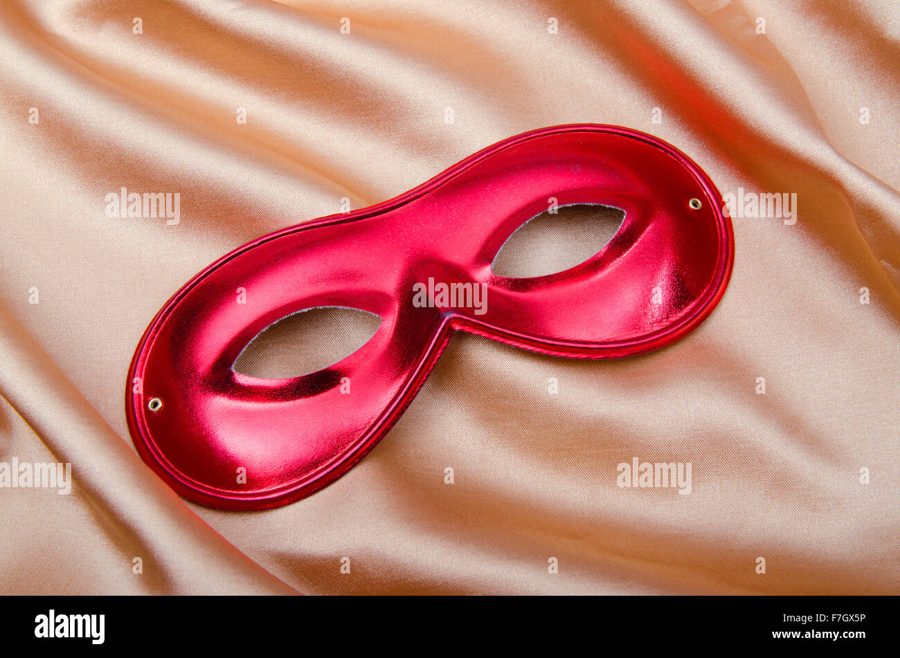 Carnical mask on satin background Stock Photo - Alamy