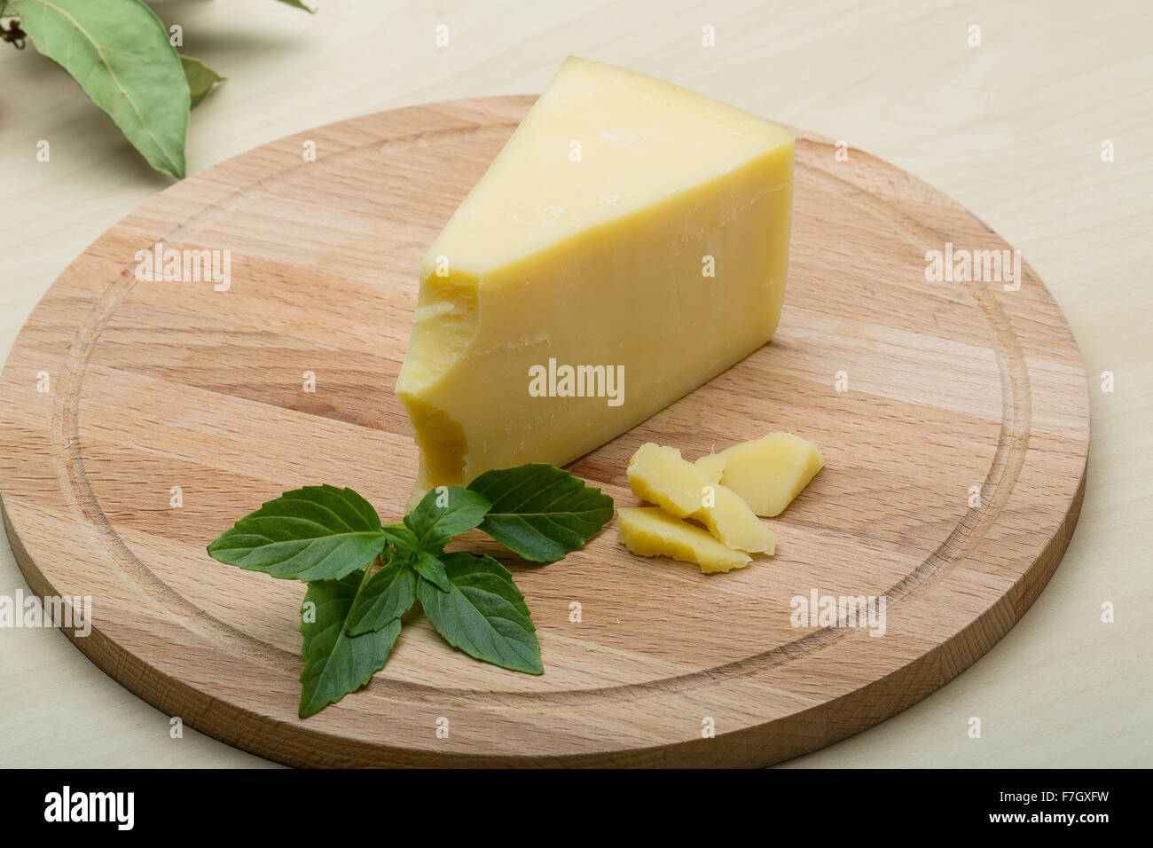 Parmesan cheese with basil leaves on the wood background Stock Photo ...