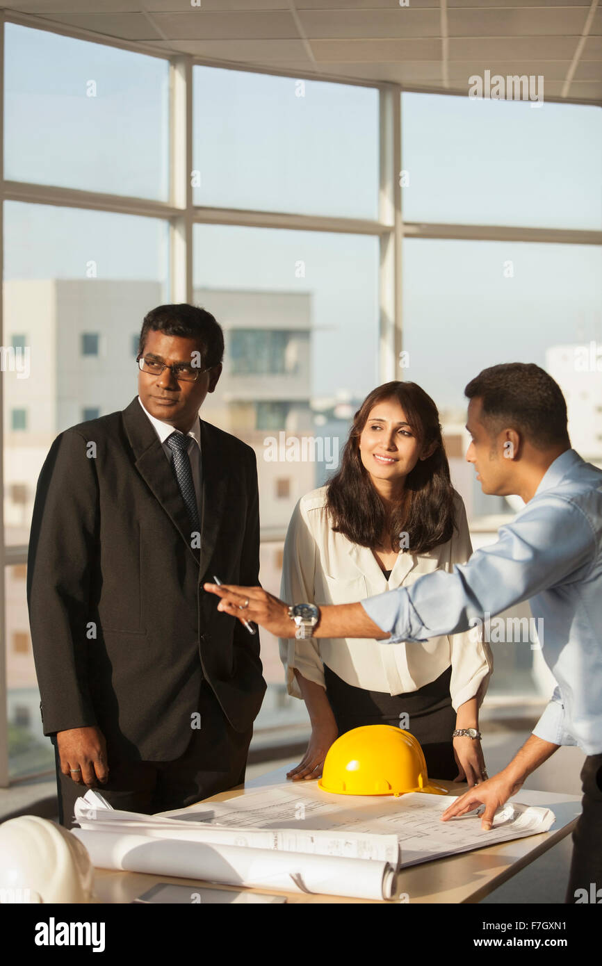 Singapore, Architect discussing building plans with customers Stock ...