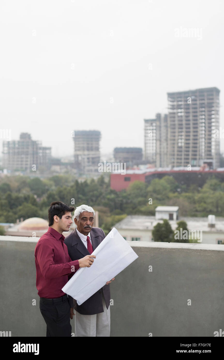 India, Architects and client discussing building plans Stock Photo - Alamy