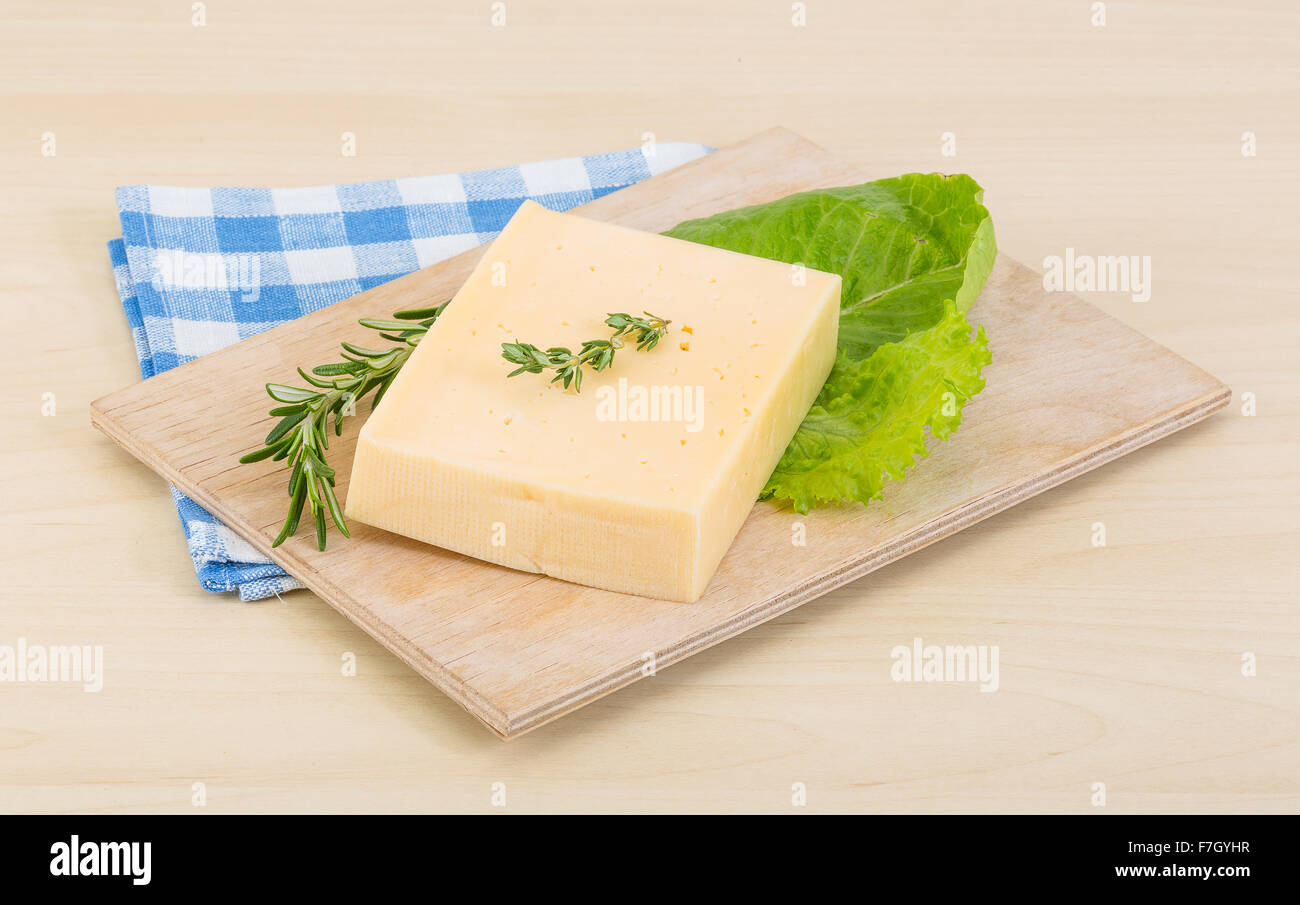 Yellow cheese brick with rosemary and thyme Stock Photo - Alamy