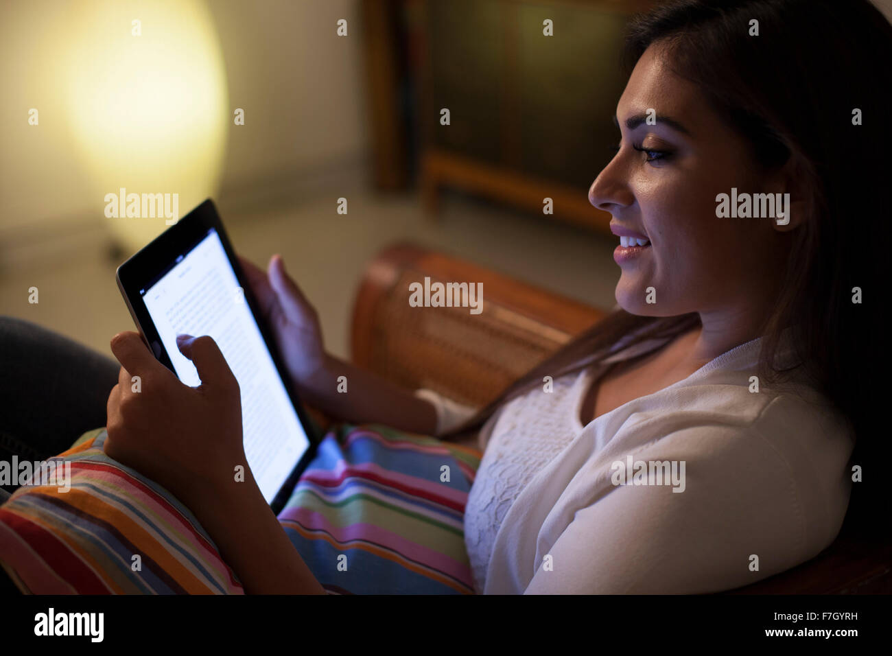 Singapore, Side view of woman looking using tablet at night Stock Photo ...