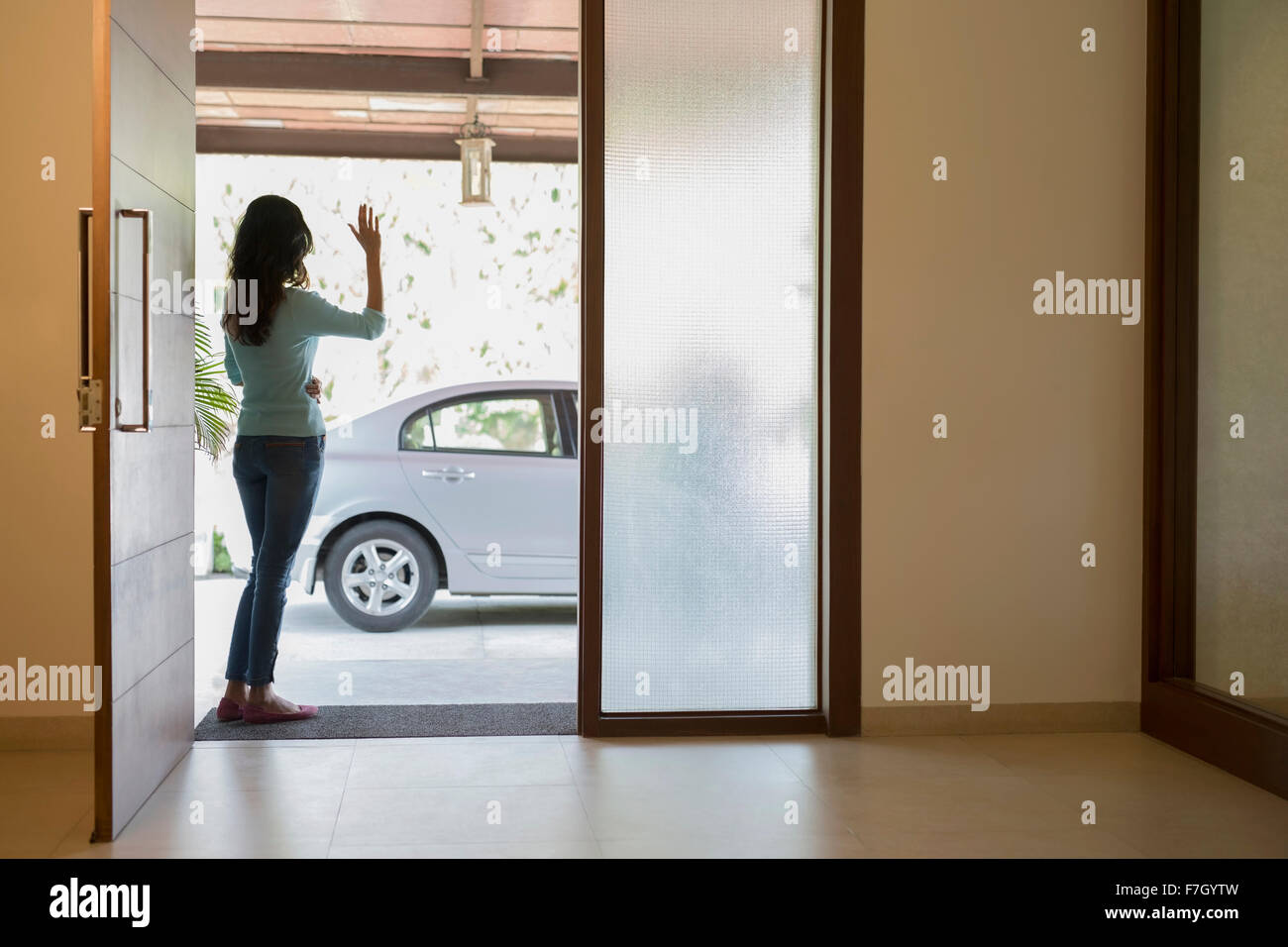 Woman waving goodbye door hi-res stock photography and images - Alamy
