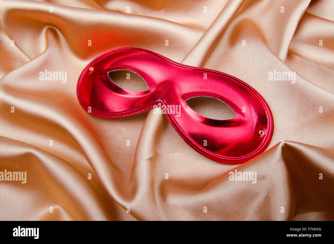Carnical mask on satin background Stock Photo - Alamy