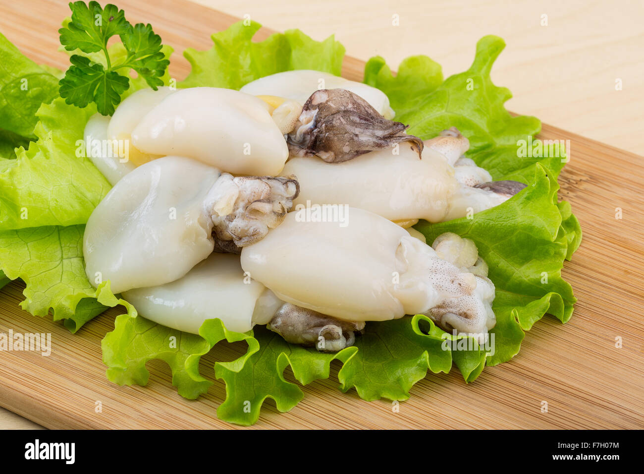 Raw cuttlefish with herbs on the wood background Stock Photo - Alamy