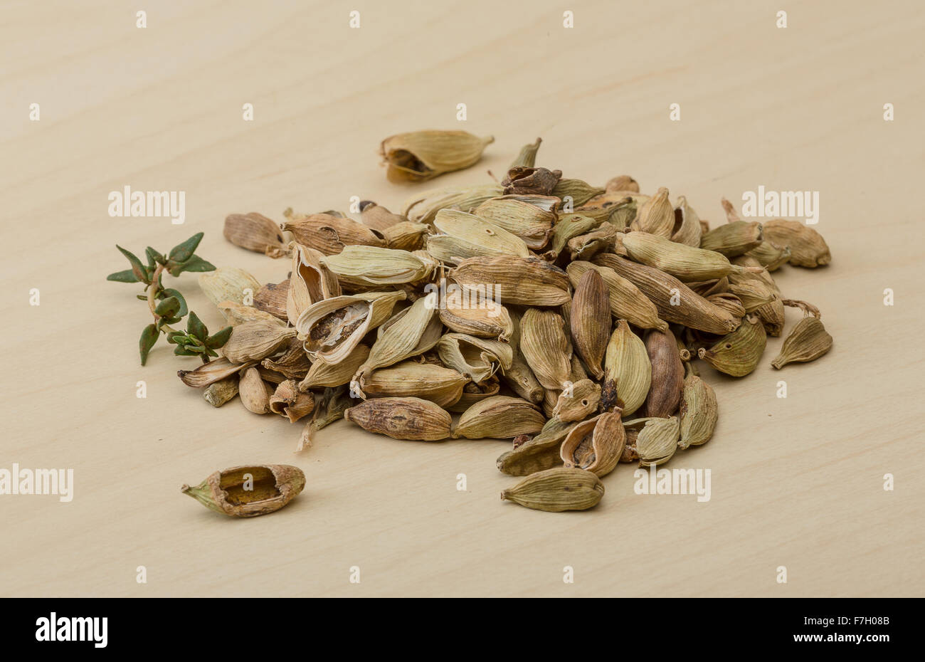 Dry Cardamom heap on the wood background Stock Photo - Alamy