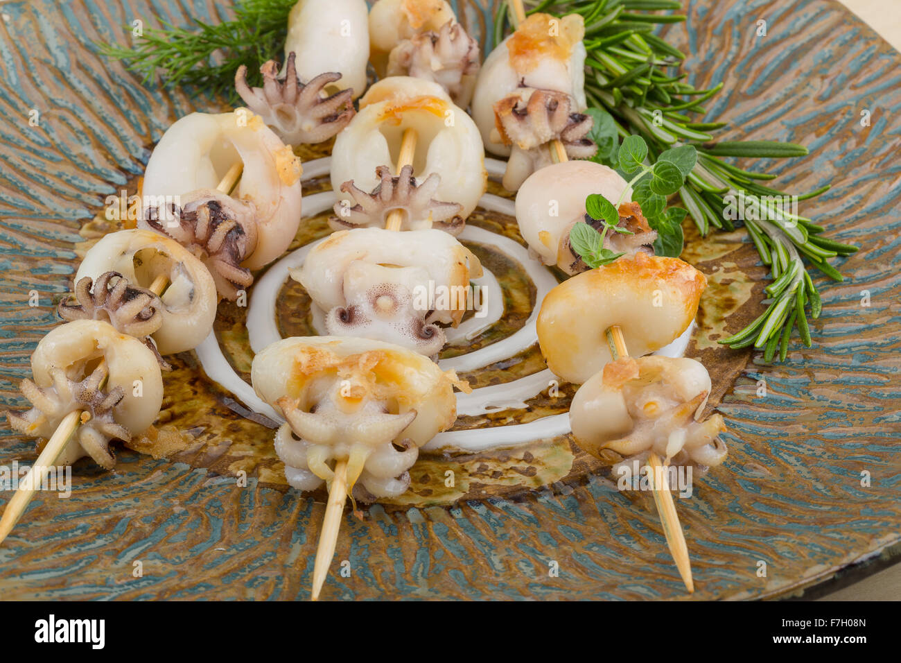 Grilled cuttlefish bbq with rosemary and pepper Stock Photo - Alamy