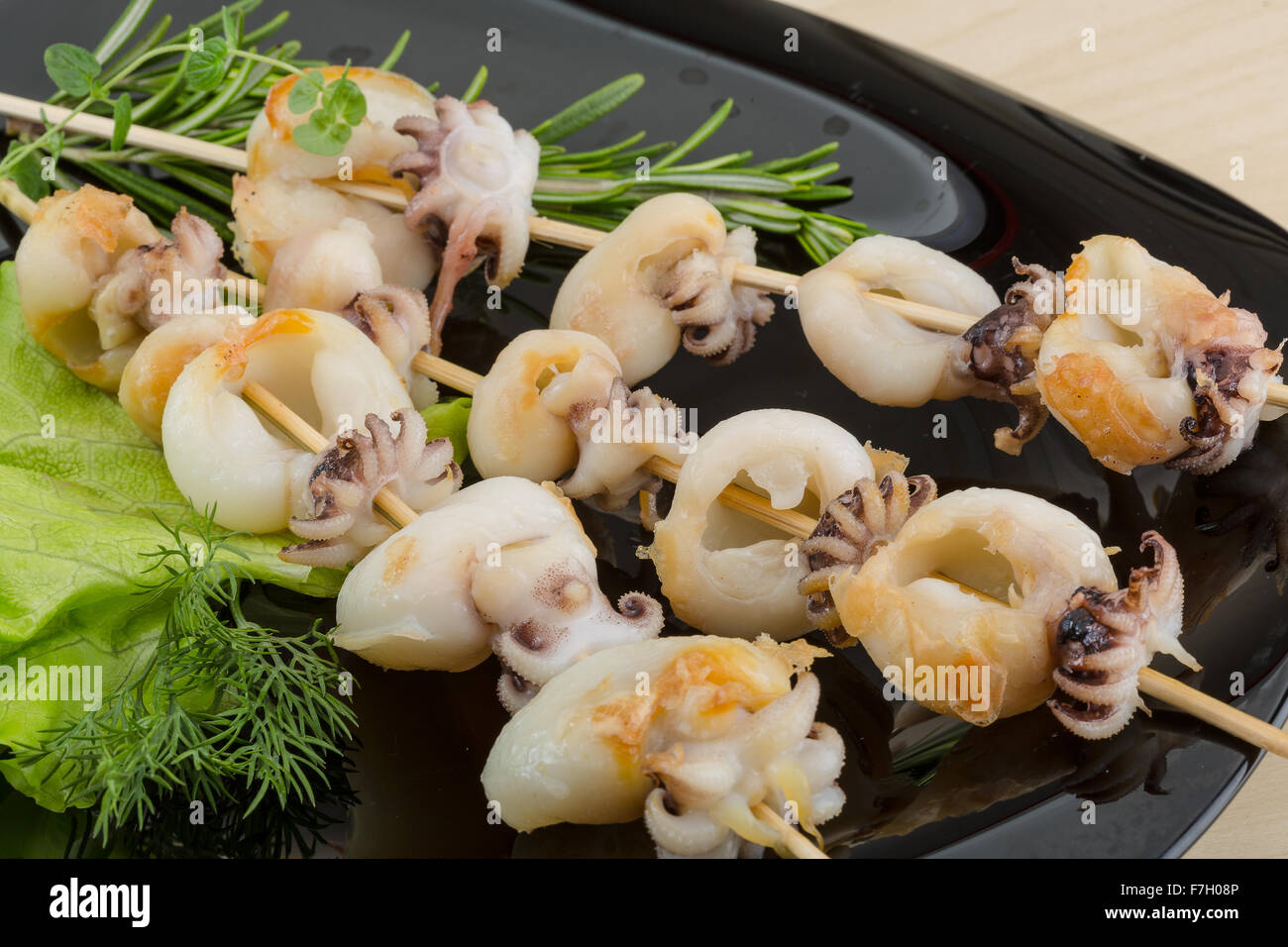 Grilled cuttlefish bbq with rosemary and pepper Stock Photo - Alamy