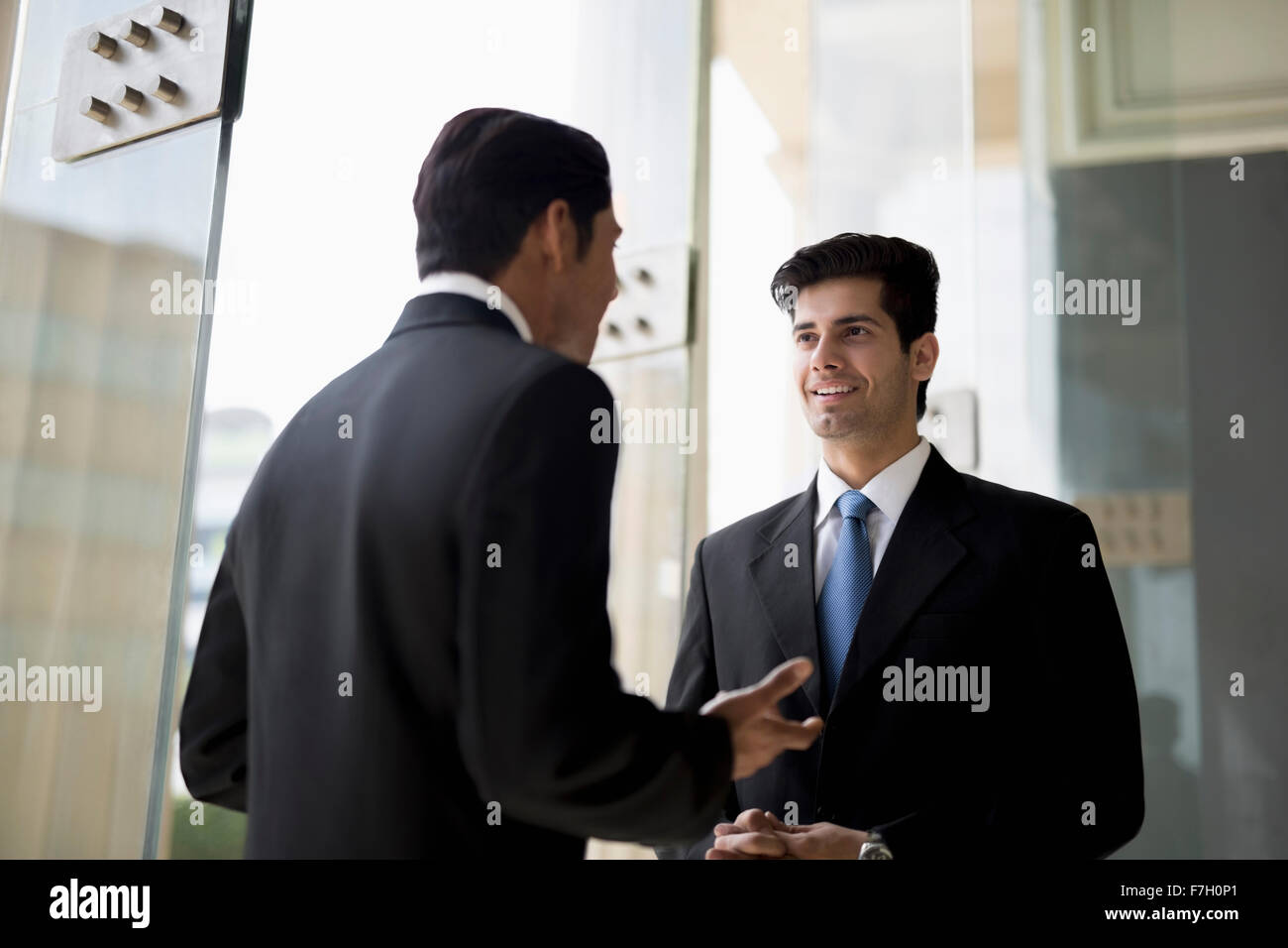 India, Two businessmen in suits talking Stock Photo - Alamy