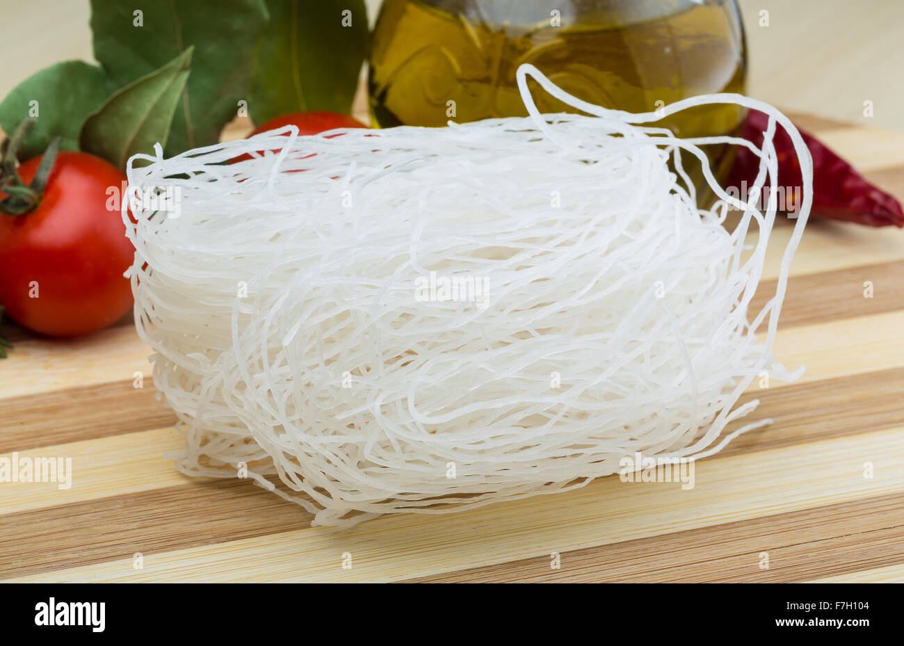 Raw Dry rice noodles on the wood background Stock Photo - Alamy