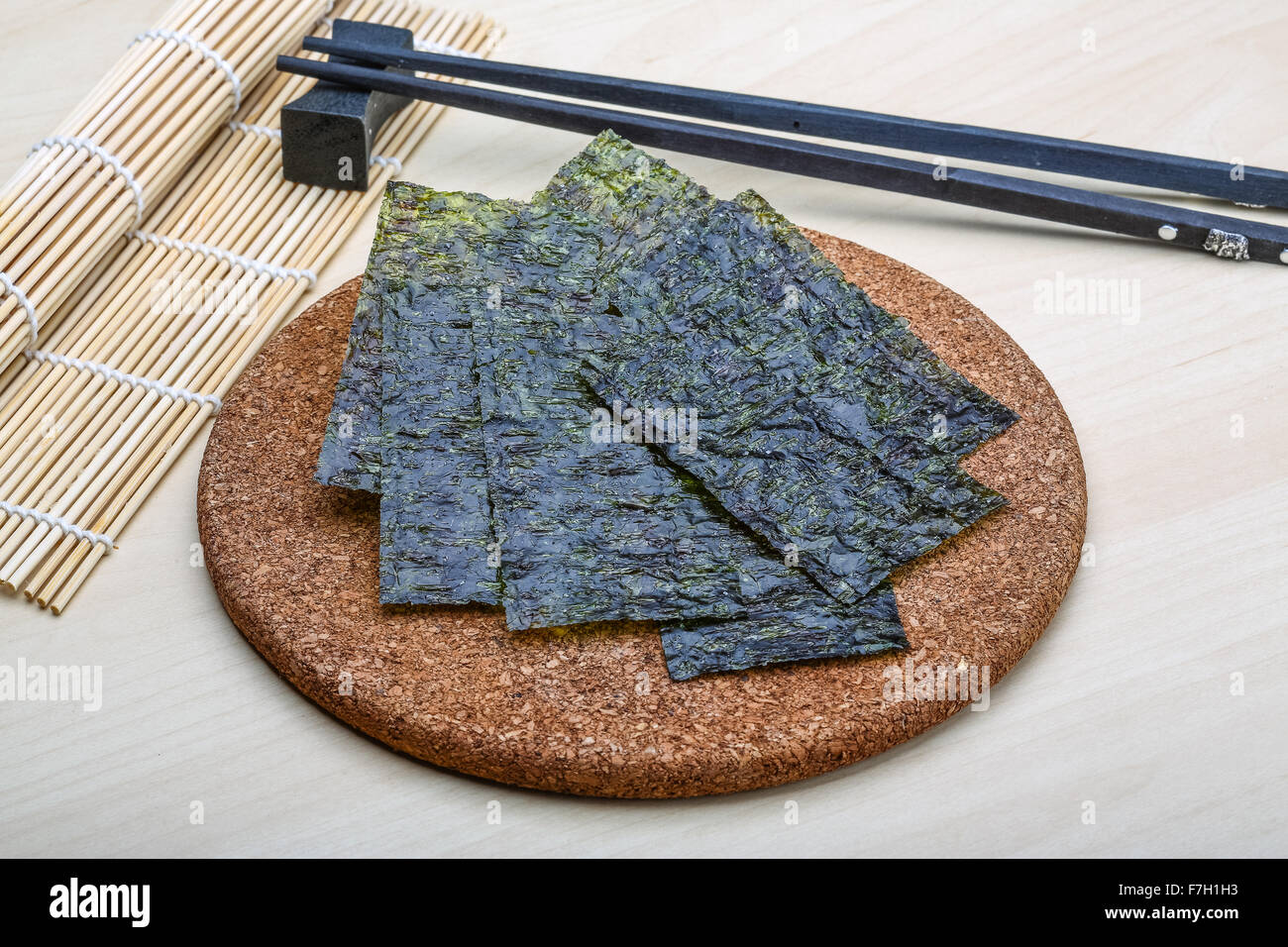 Nori sheets with sticks on the wood background Stock Photo - Alamy