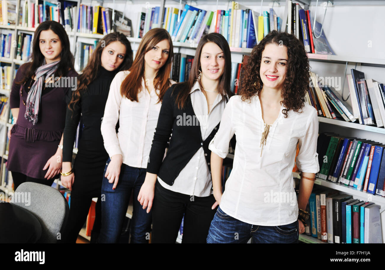happy student woman group portrait at library Stock Photo - Alamy