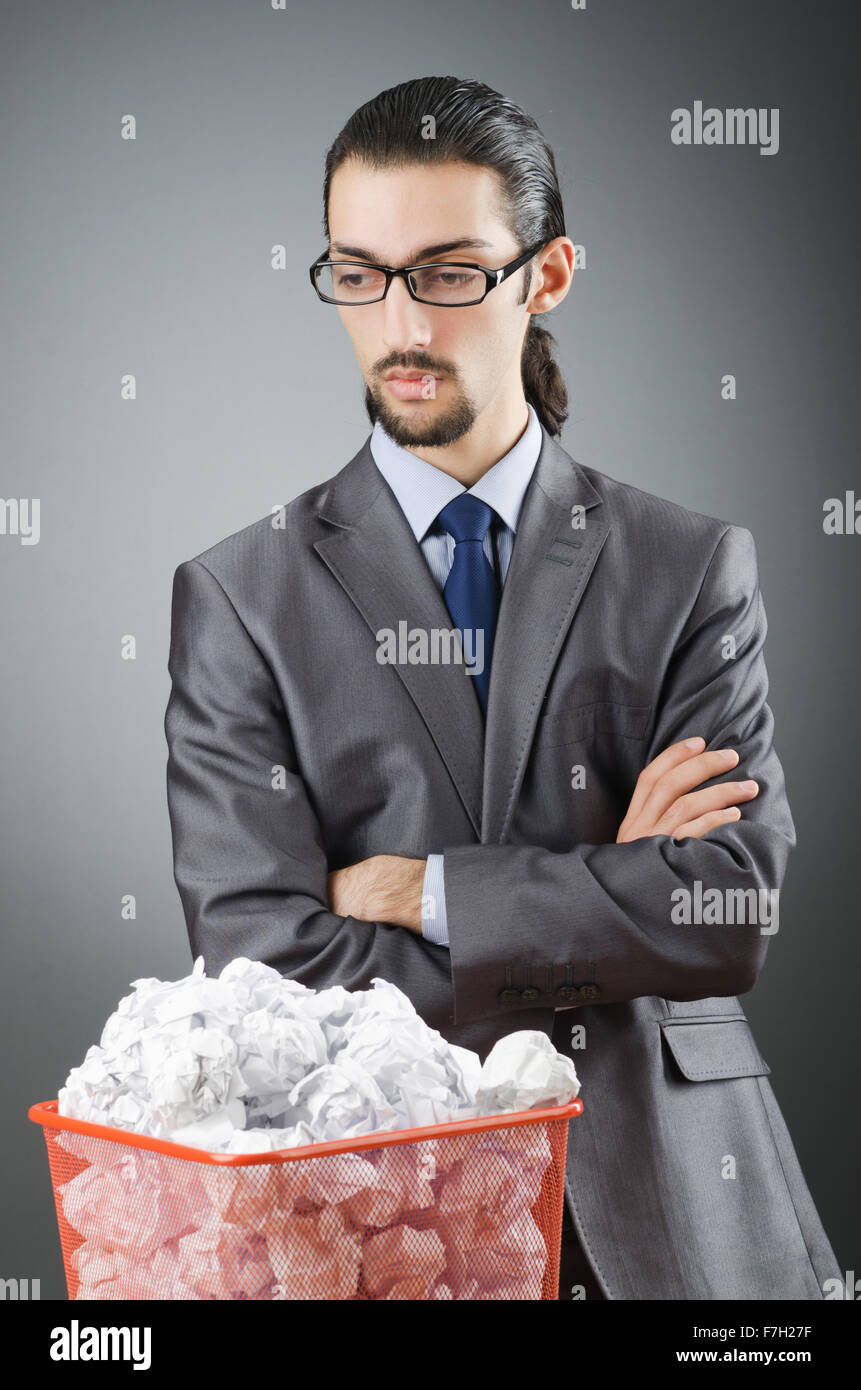 Man with lots of wasted paper Stock Photo - Alamy