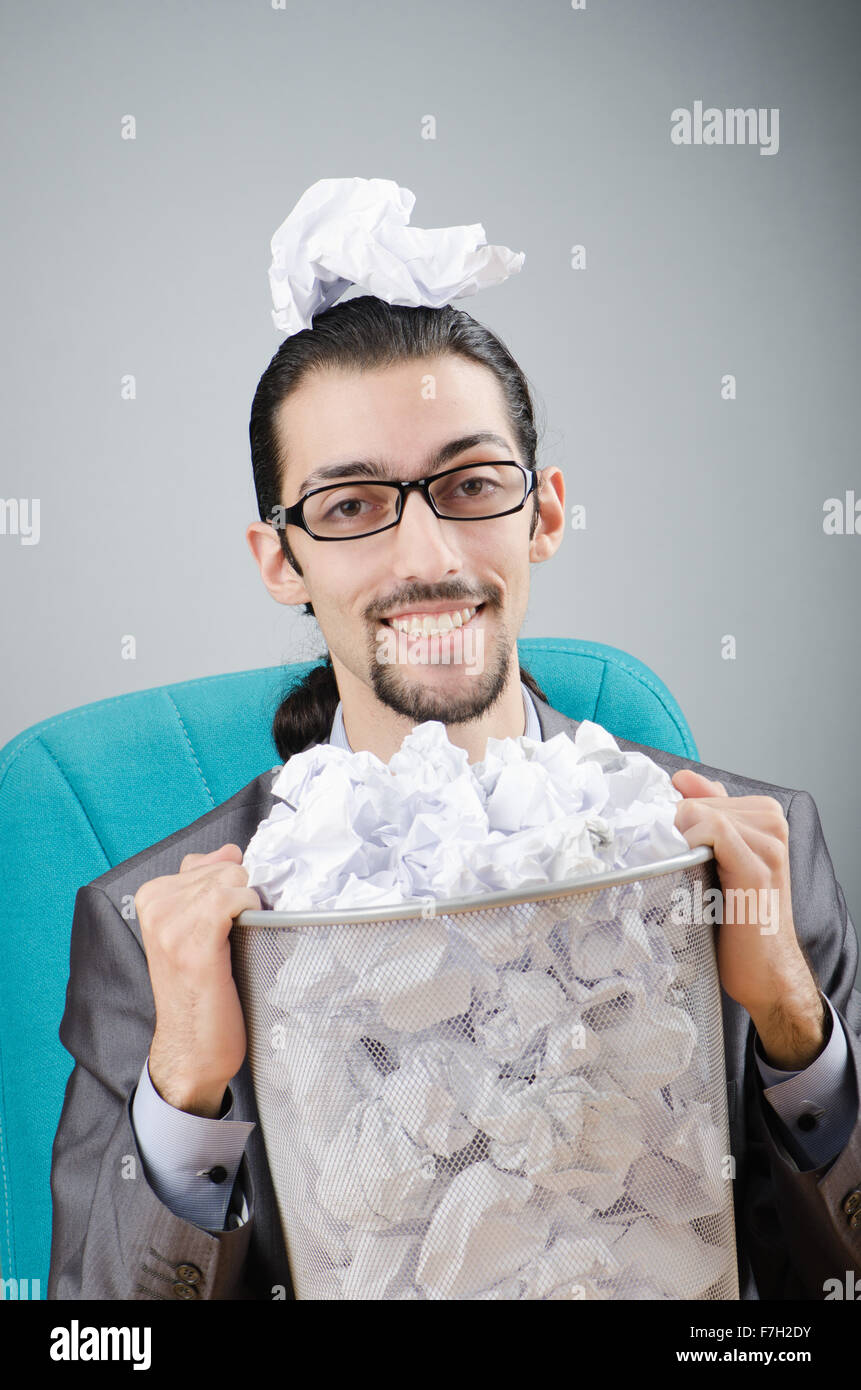 Man with lots of wasted paper Stock Photo - Alamy