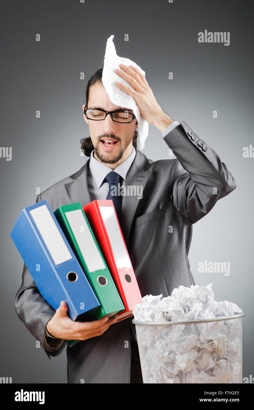 Man with lots of wasted paper Stock Photo - Alamy