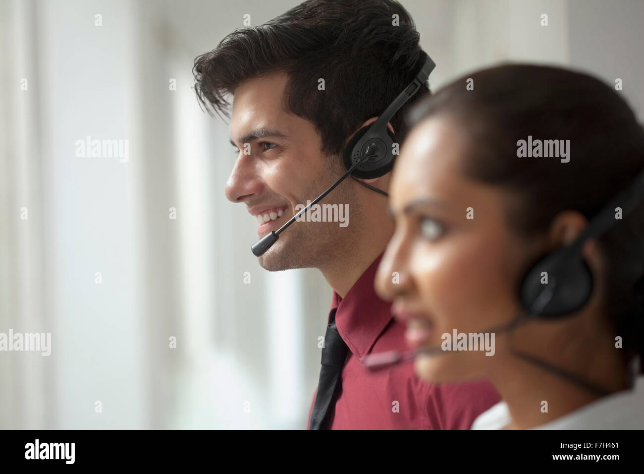 India, Two tele sales people with headphones Stock Photo - Alamy