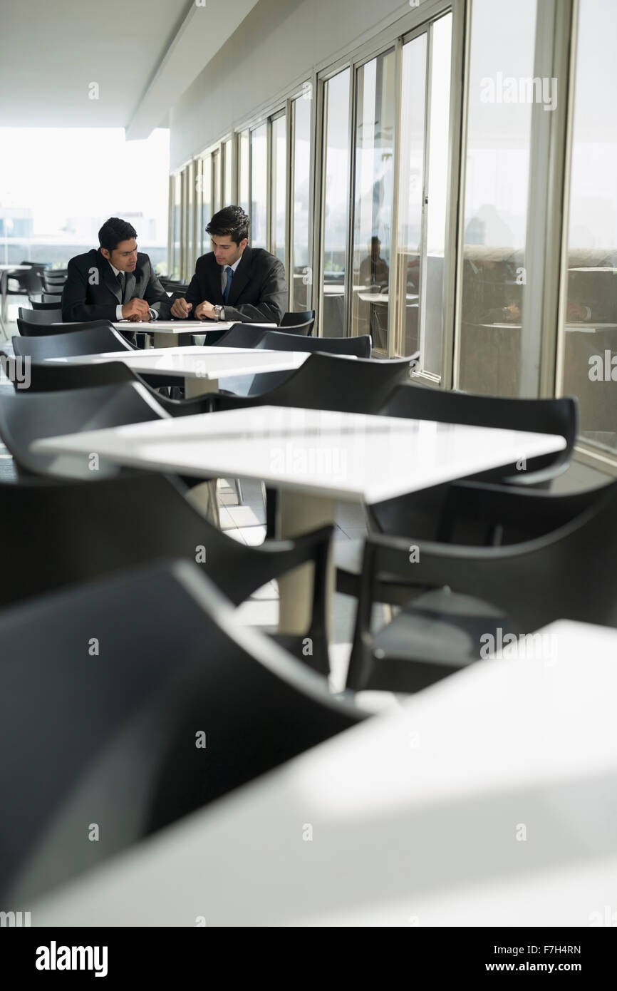 India, Two colleagues working at table in cafeteria Stock Photo - Alamy