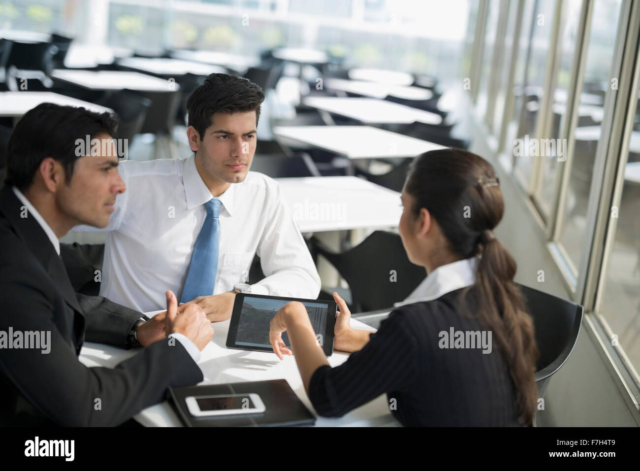 India, Three colleagues working in cafeteria Stock Photo - Alamy