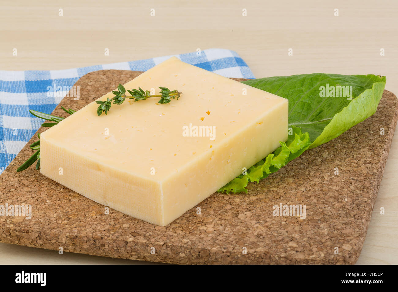Yellow cheese brick with rosemary and thyme Stock Photo - Alamy
