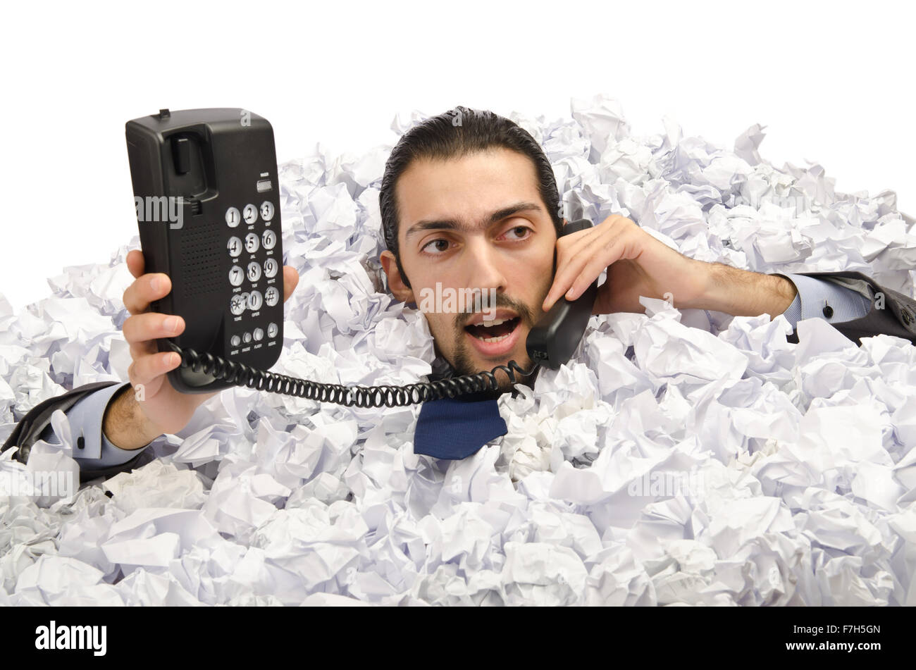 Man with lots of crumpled paper Stock Photo - Alamy