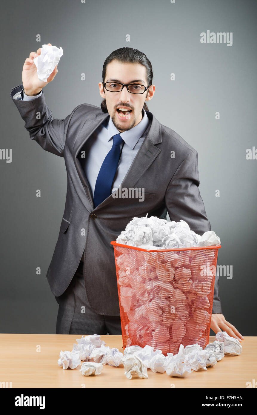 Man with lots of wasted paper Stock Photo - Alamy