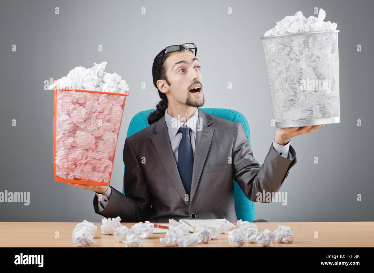 Man with lots of wasted paper Stock Photo - Alamy