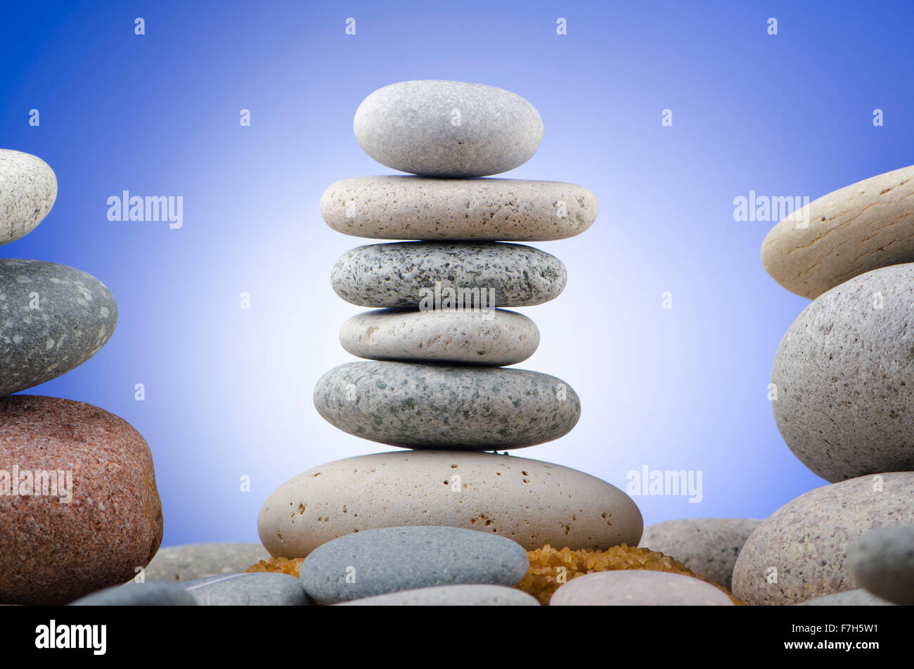 Balanced pebbles with colour background Stock Photo - Alamy