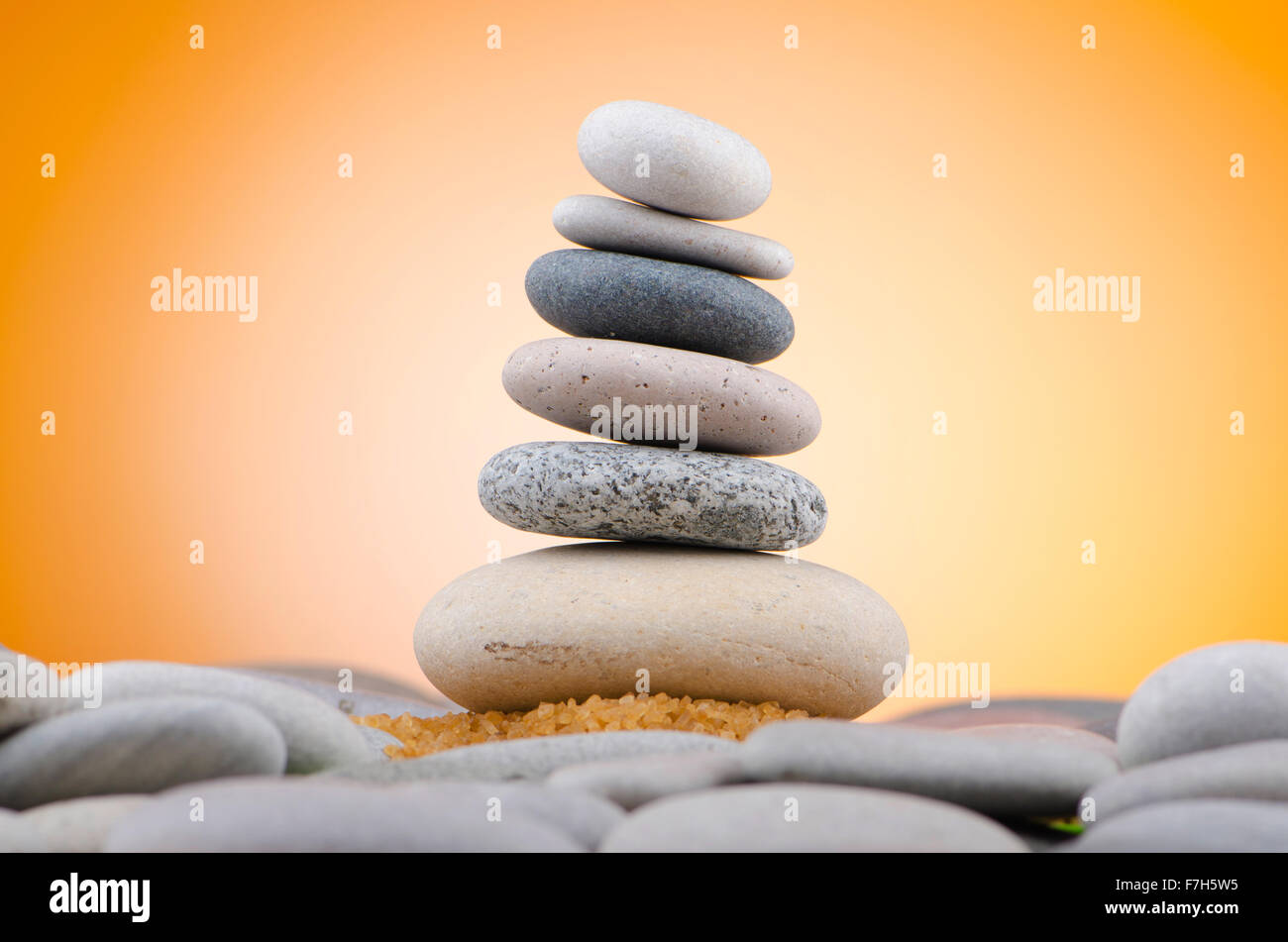 Balanced pebbles with colour background Stock Photo - Alamy
