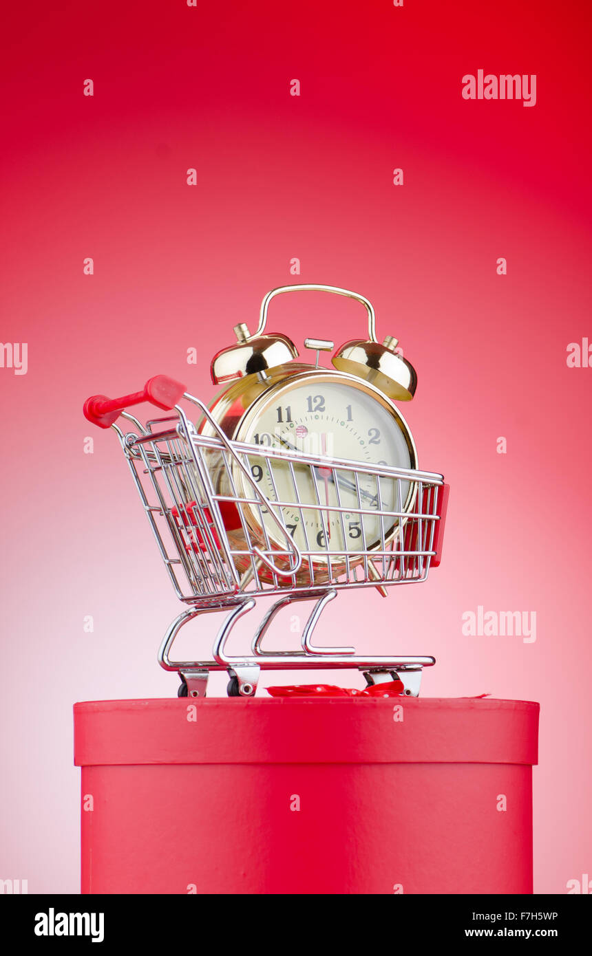 Buying time concept with clock and shopping cart Stock Photo - Alamy