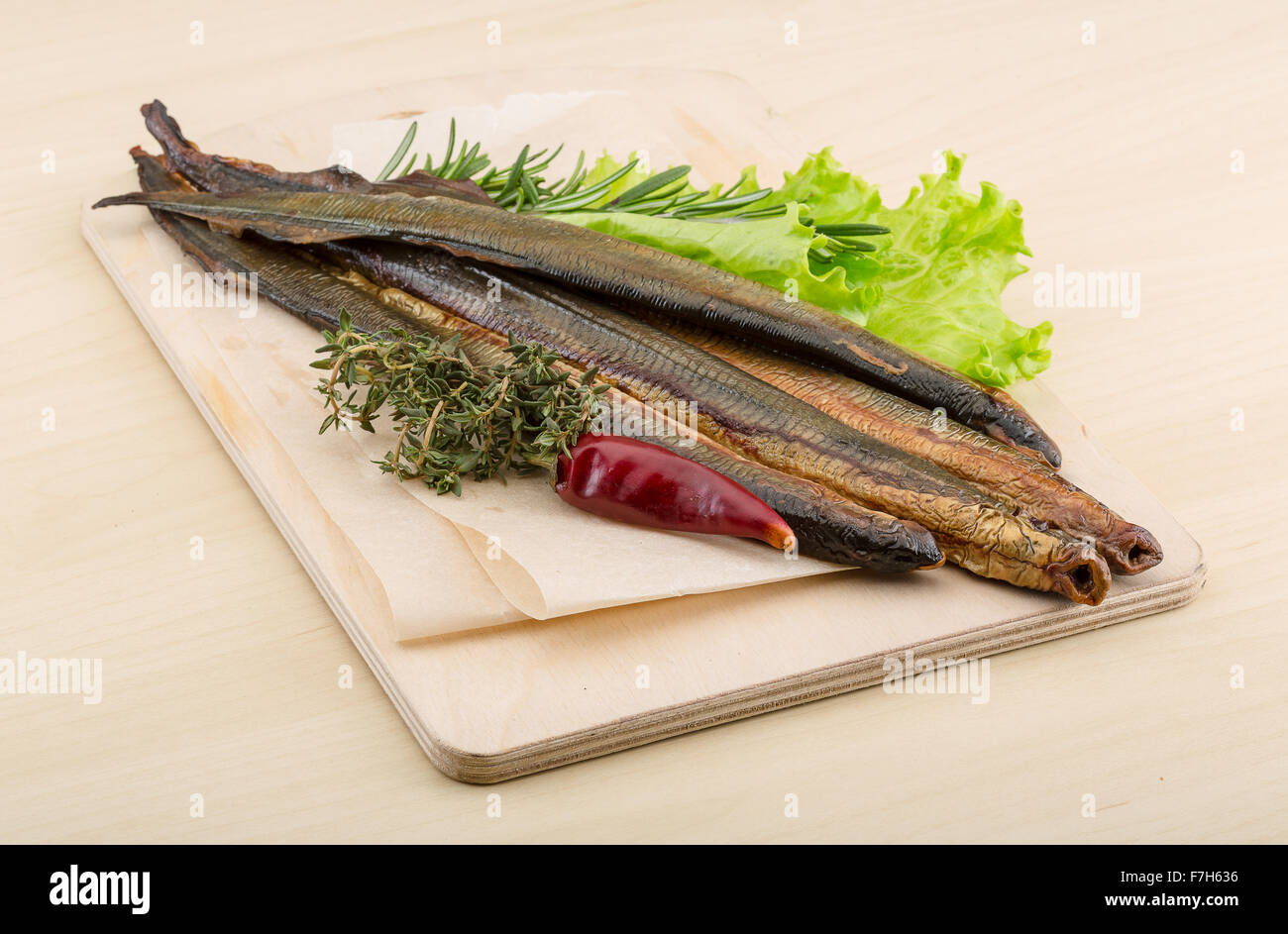 Smoked Lamprey - seafood delicacy with salad and herbs Stock Photo - Alamy