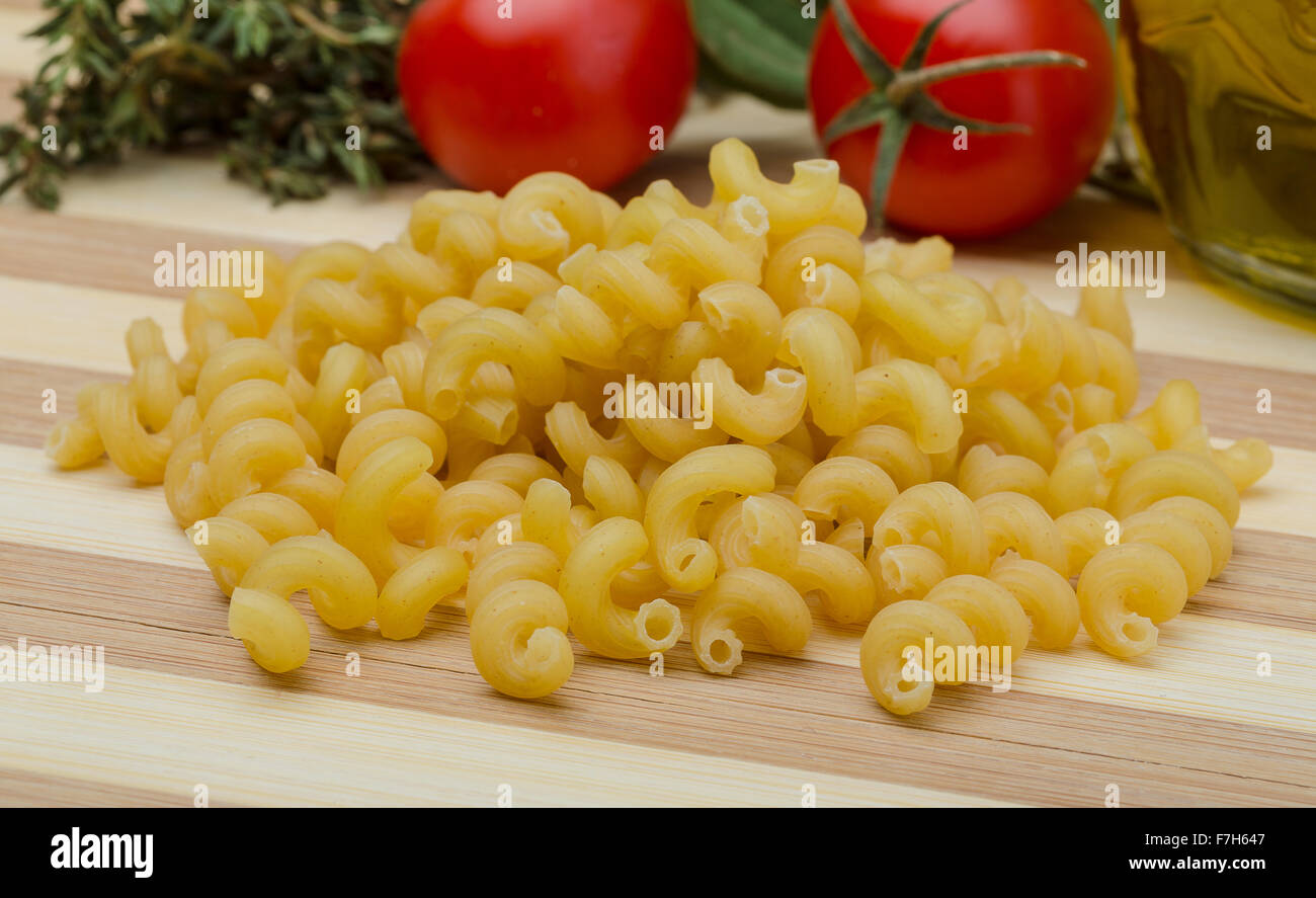 Raw Cellentani pasta on the wood background Stock Photo - Alamy