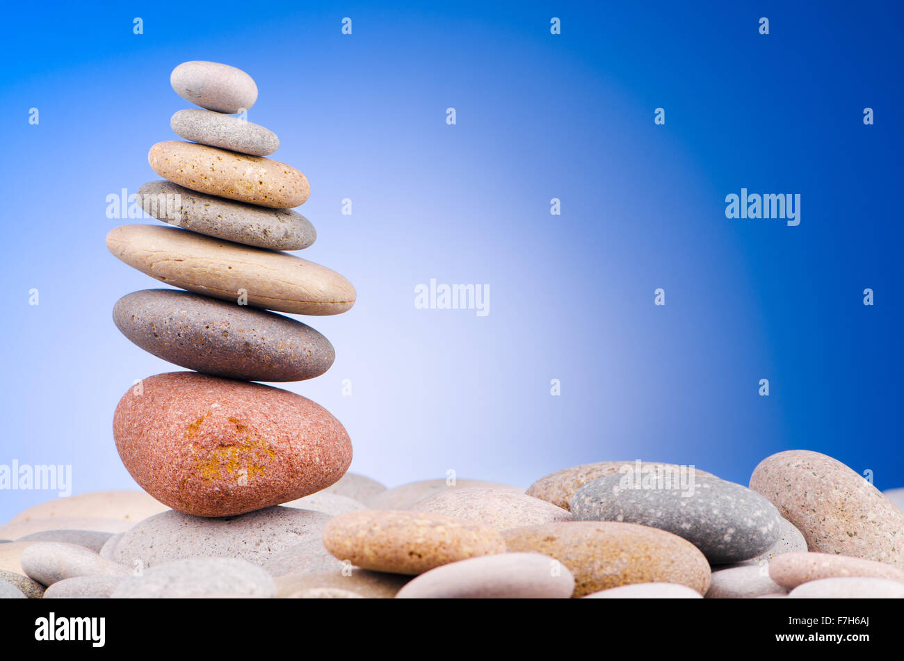 Pebbles stack against gradient background Stock Photo - Alamy