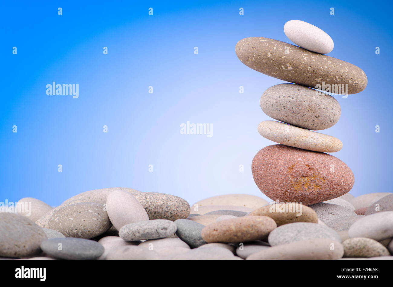 Pebbles stack against gradient background Stock Photo - Alamy