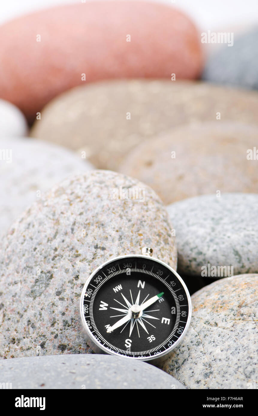 Navigation compass on stone pebbles Stock Photo - Alamy