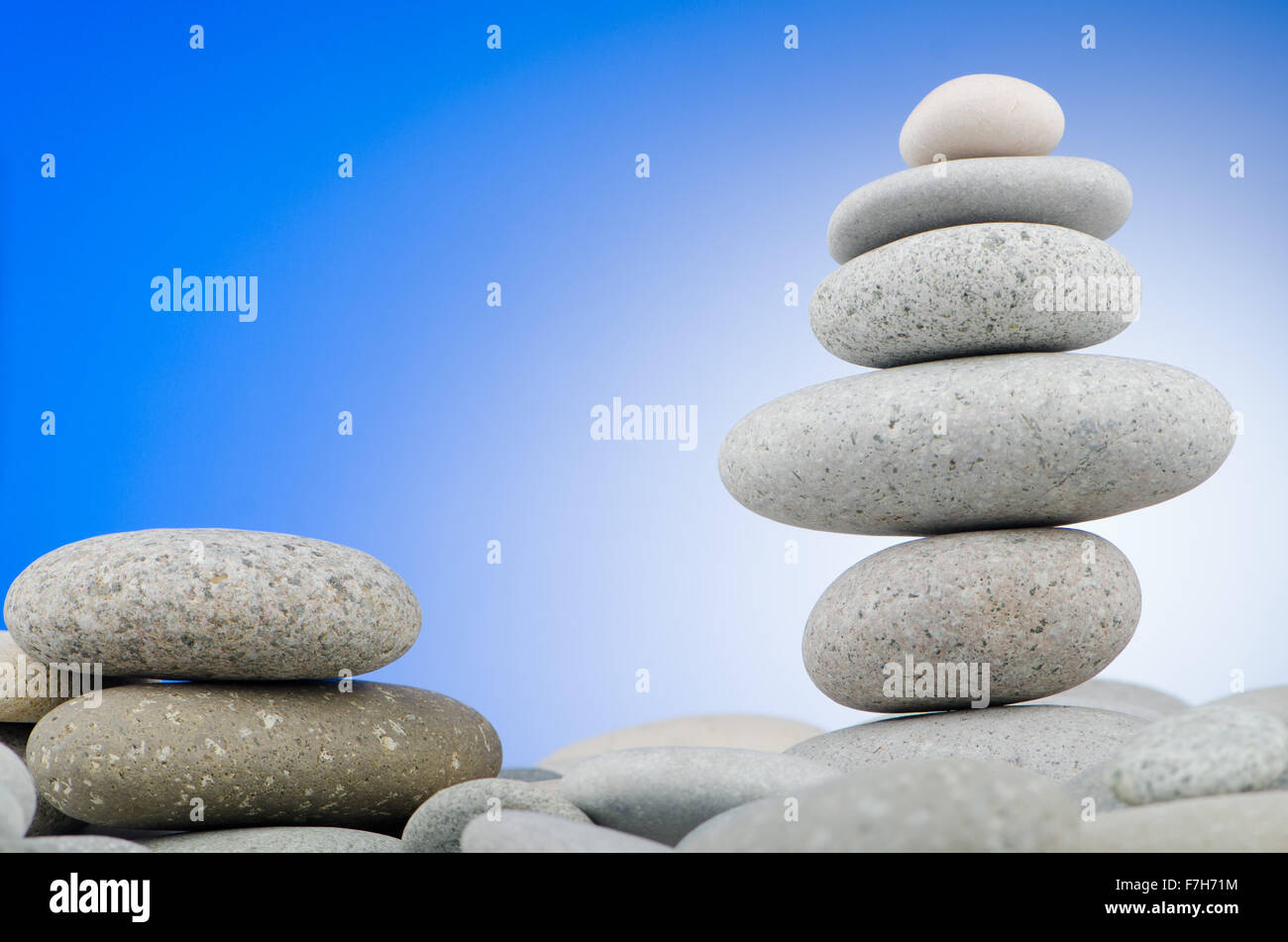 Pebbles stack against gradient background Stock Photo - Alamy